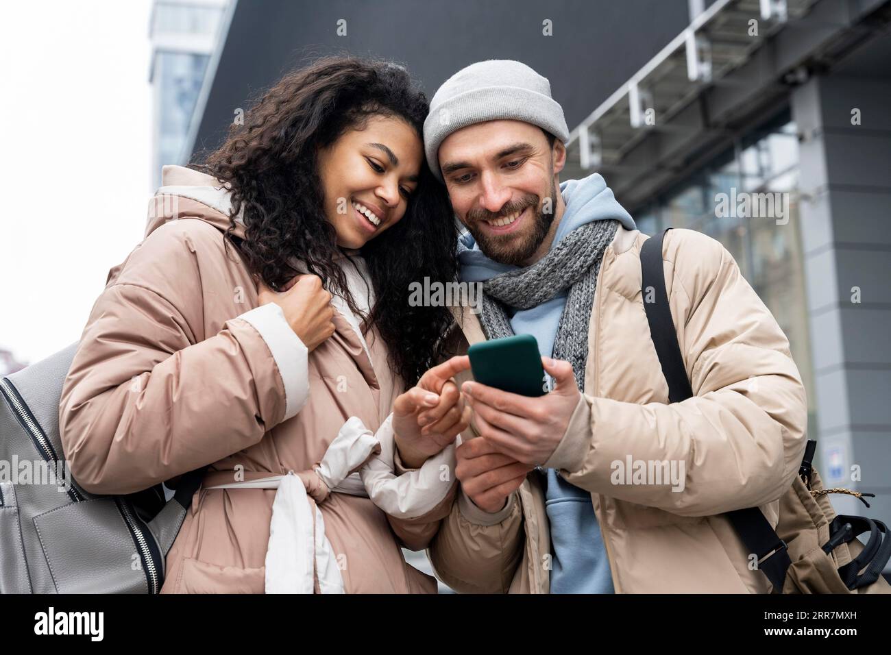 Medium shot people looking phone Stock Photo - Alamy