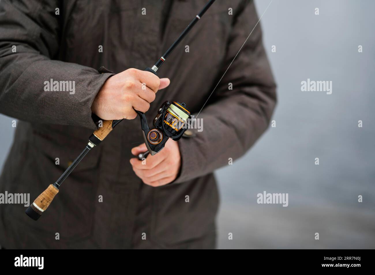Man using fishing rod Stock Photo - Alamy