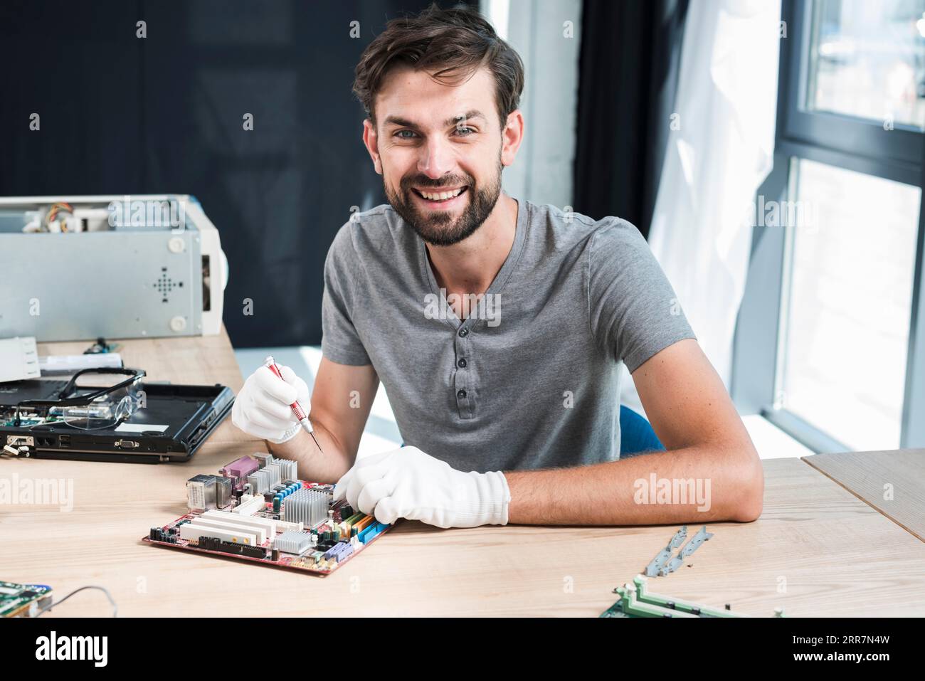Portrait smiling male technician working computer motherboard Stock ...