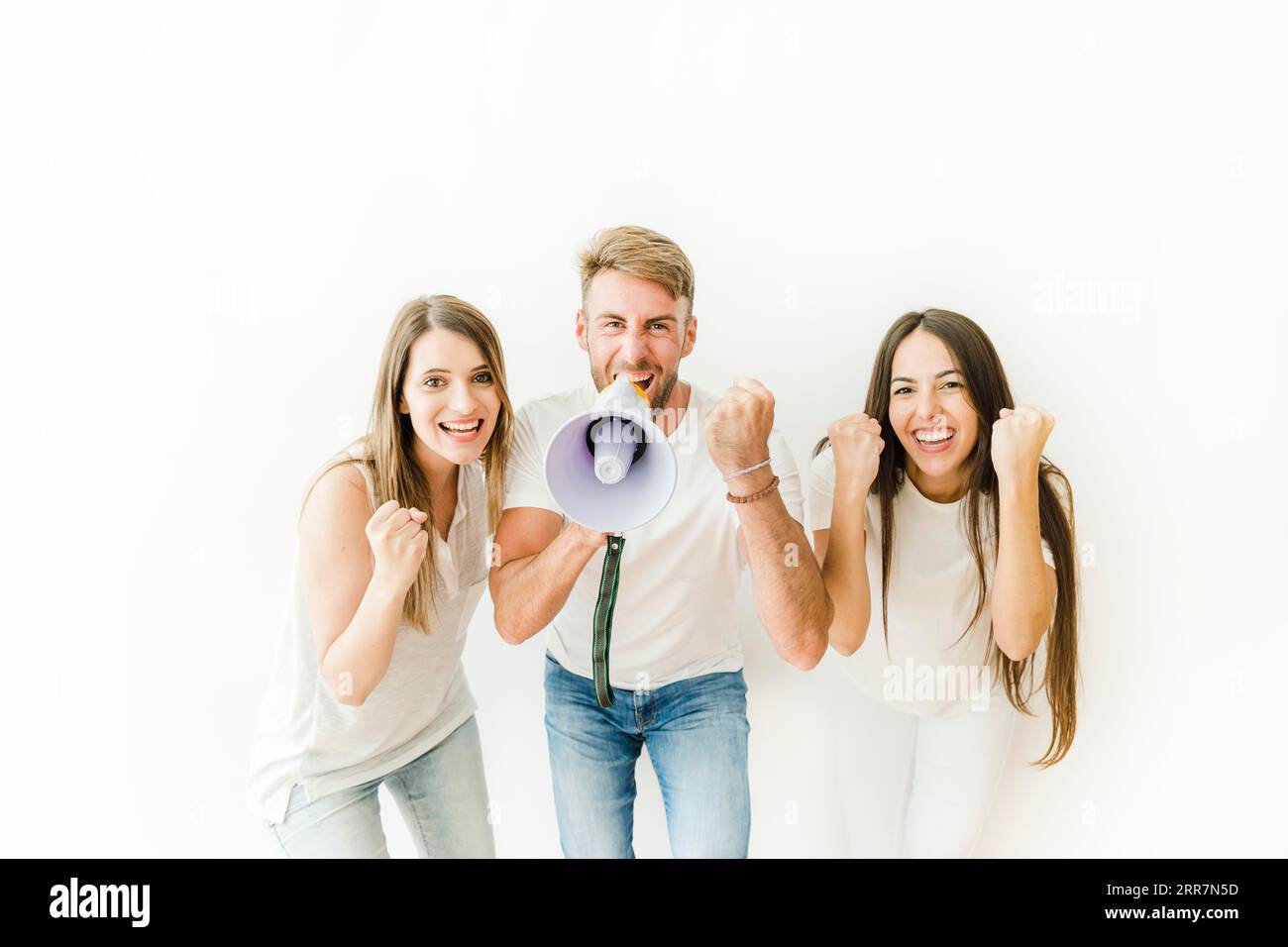 People cheering with megaphone studio Stock Photo - Alamy