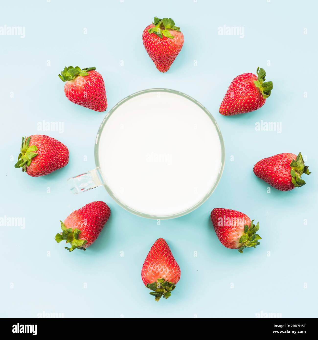 Overhead view strawberries milk blue backdrop Stock Photo - Alamy
