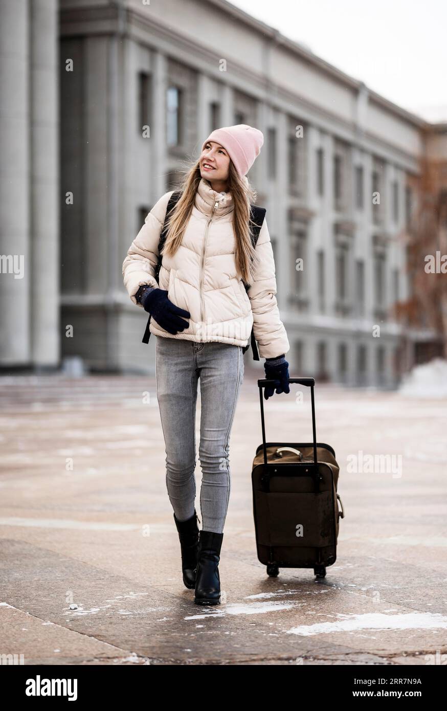 Portrait female student with luggage Stock Photo - Alamy