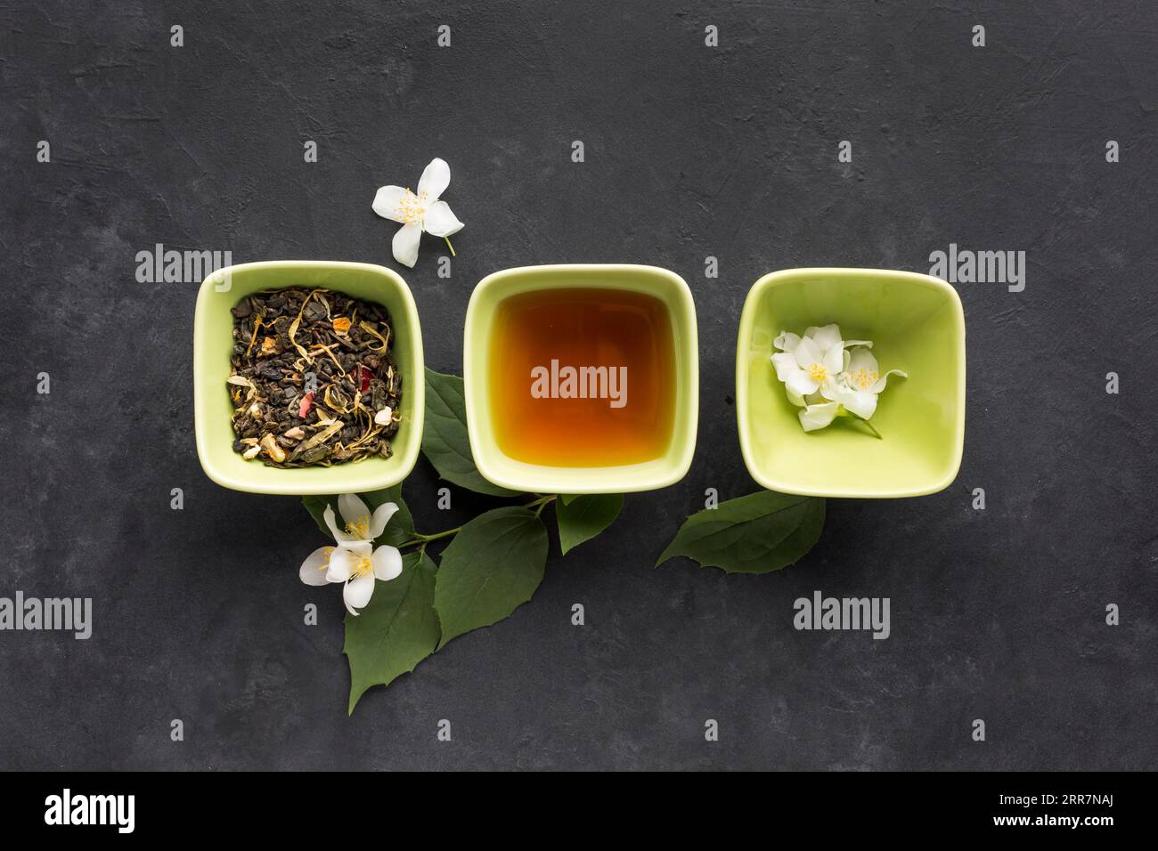 Row healthy tea ingredient white jasmine flower black surface Stock ...