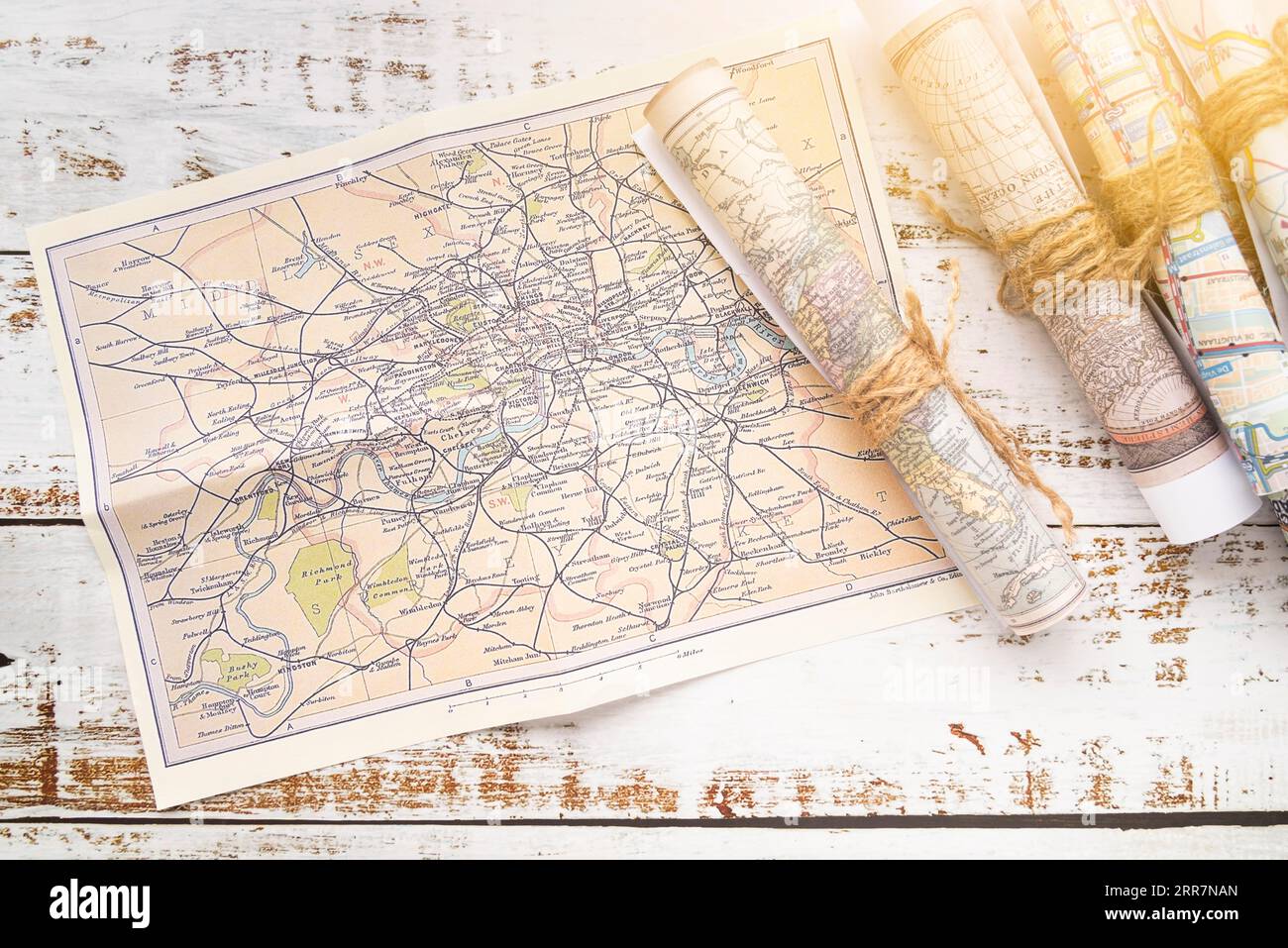 Rolled maps wooden desk Stock Photo - Alamy