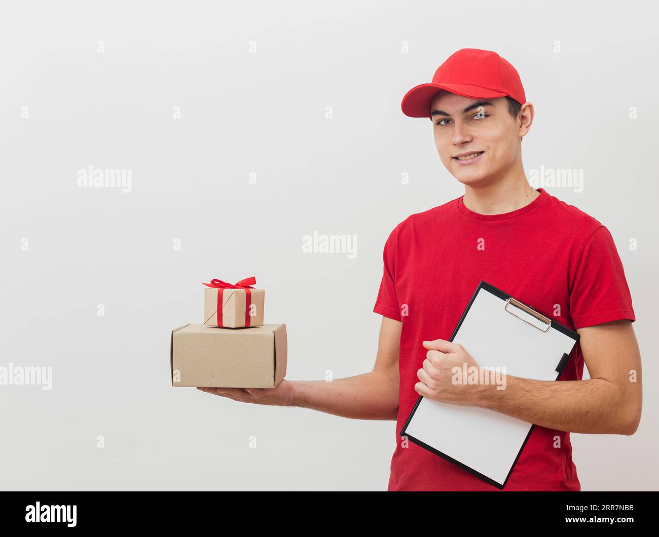 Smiley delivery employee with packages Stock Photo - Alamy