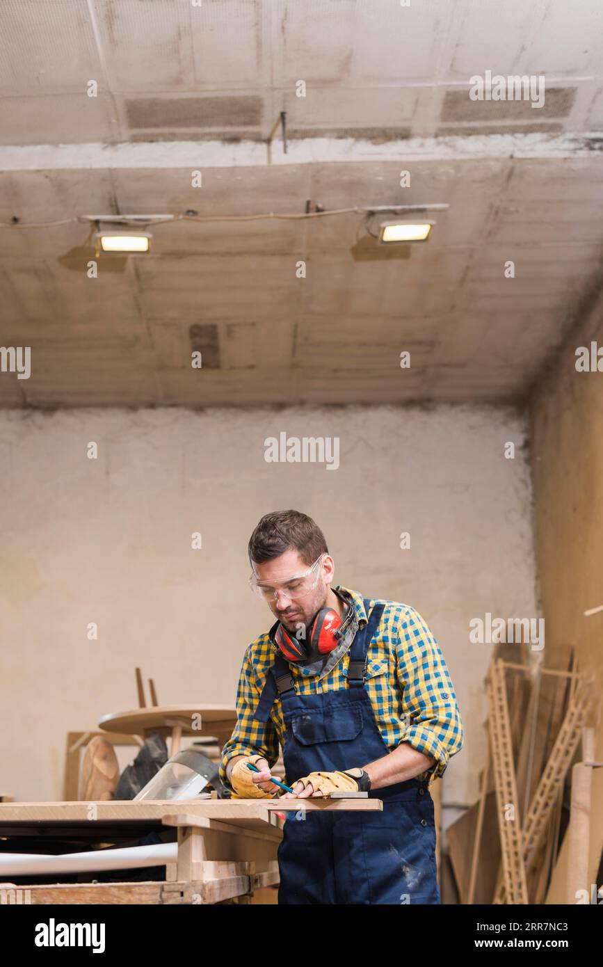 Professional male carpenter taking measurement workbench workshop Stock ...