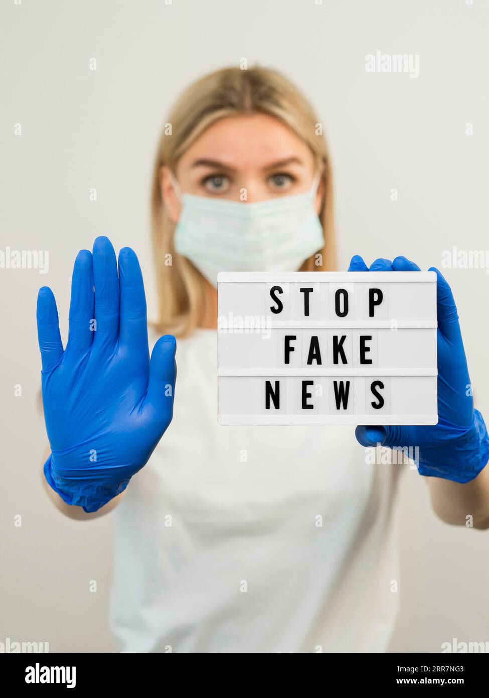Stop fake news woman wearing gloves Stock Photo - Alamy