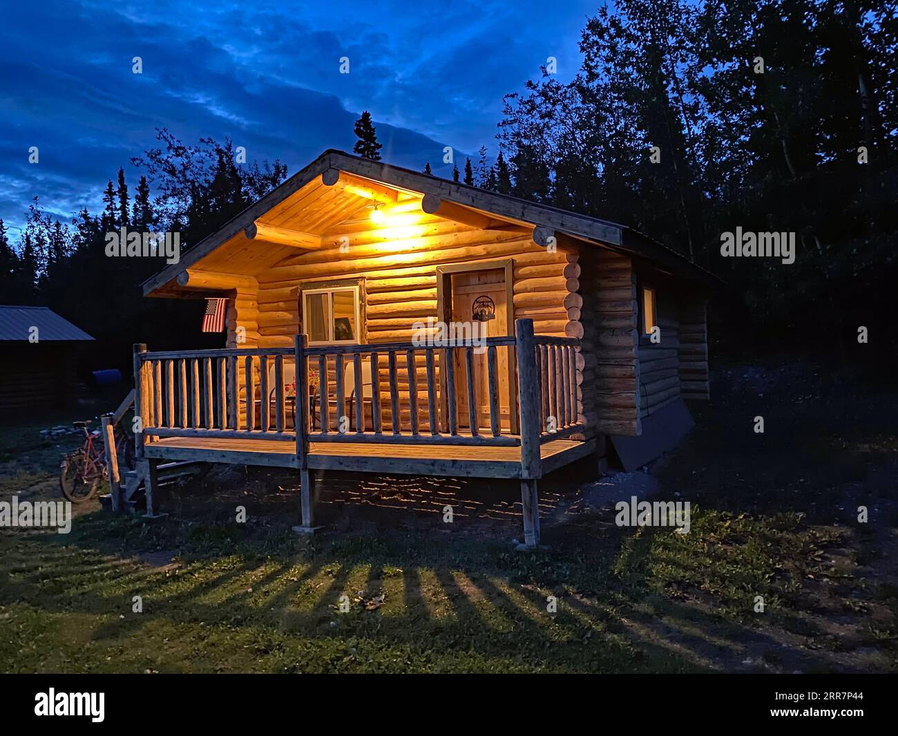 Illuminated log cabin at dusk, Kenny Lake, Alaska, USA Stock Photo - Alamy