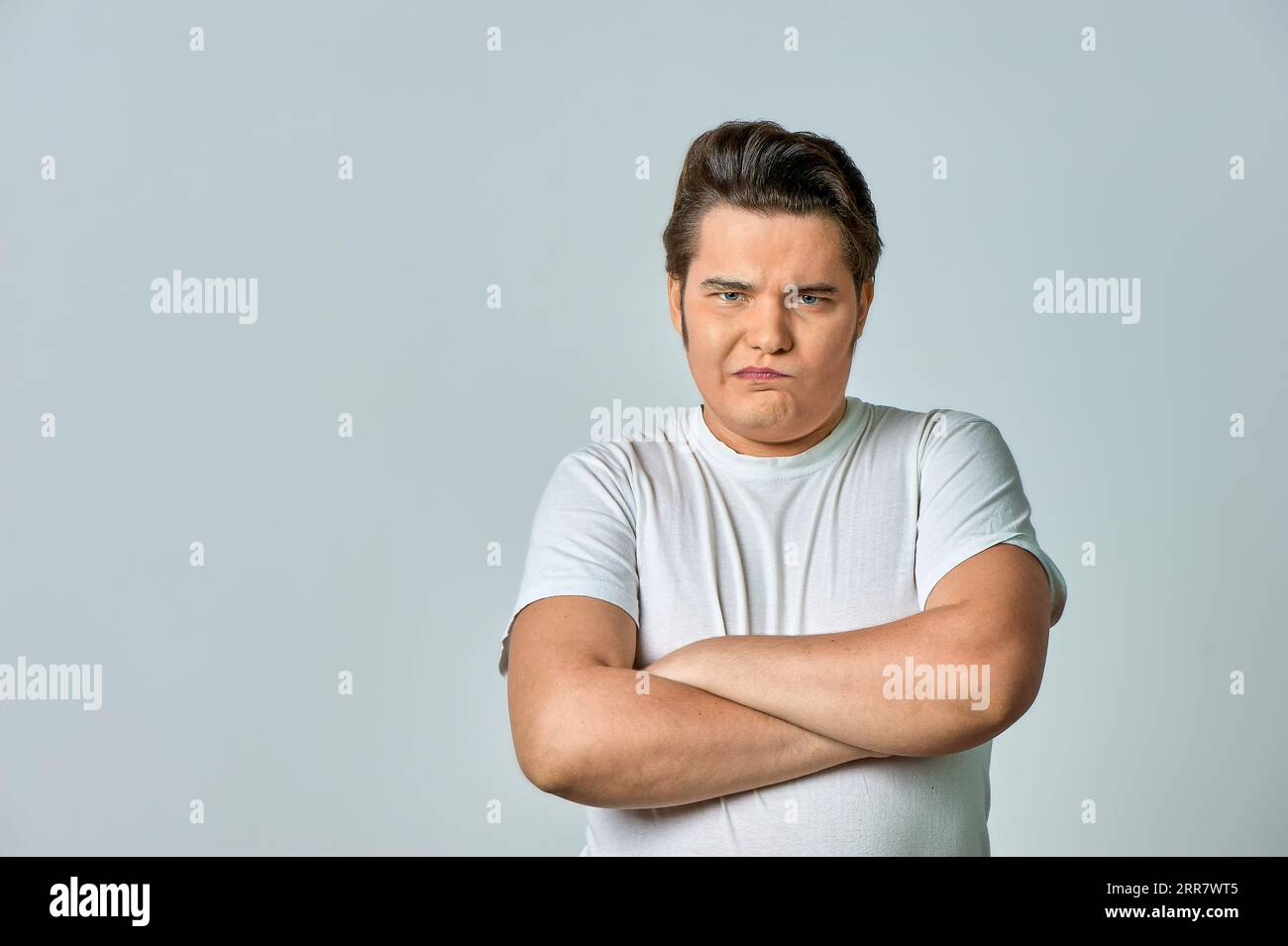 Angry, frowning man on a gray background, copy space Stock Photo - Alamy