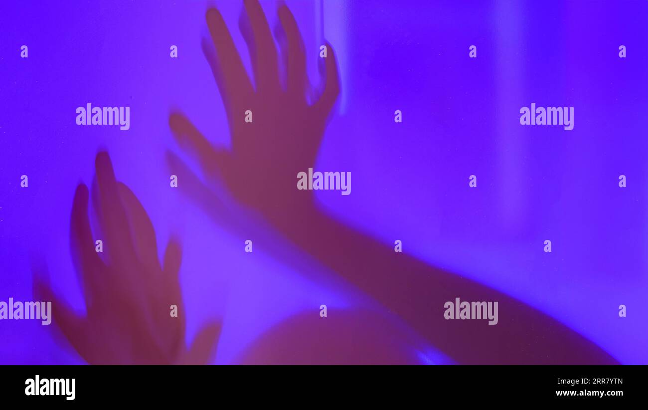 Defocused abstact silhouette of arm, hand spooky action, alien, ghost ...