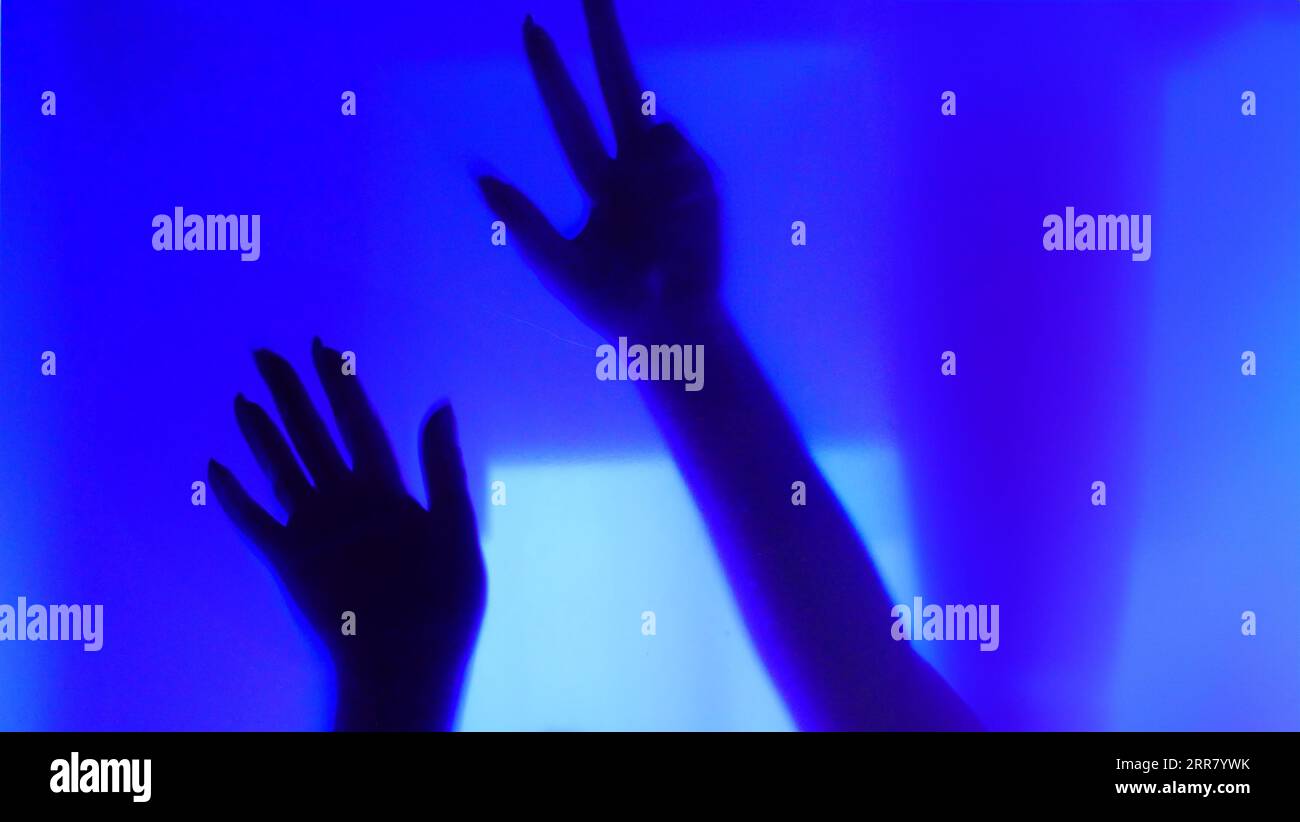 Defocused abstact silhouette of arm, hand spooky action, alien, ghost ...