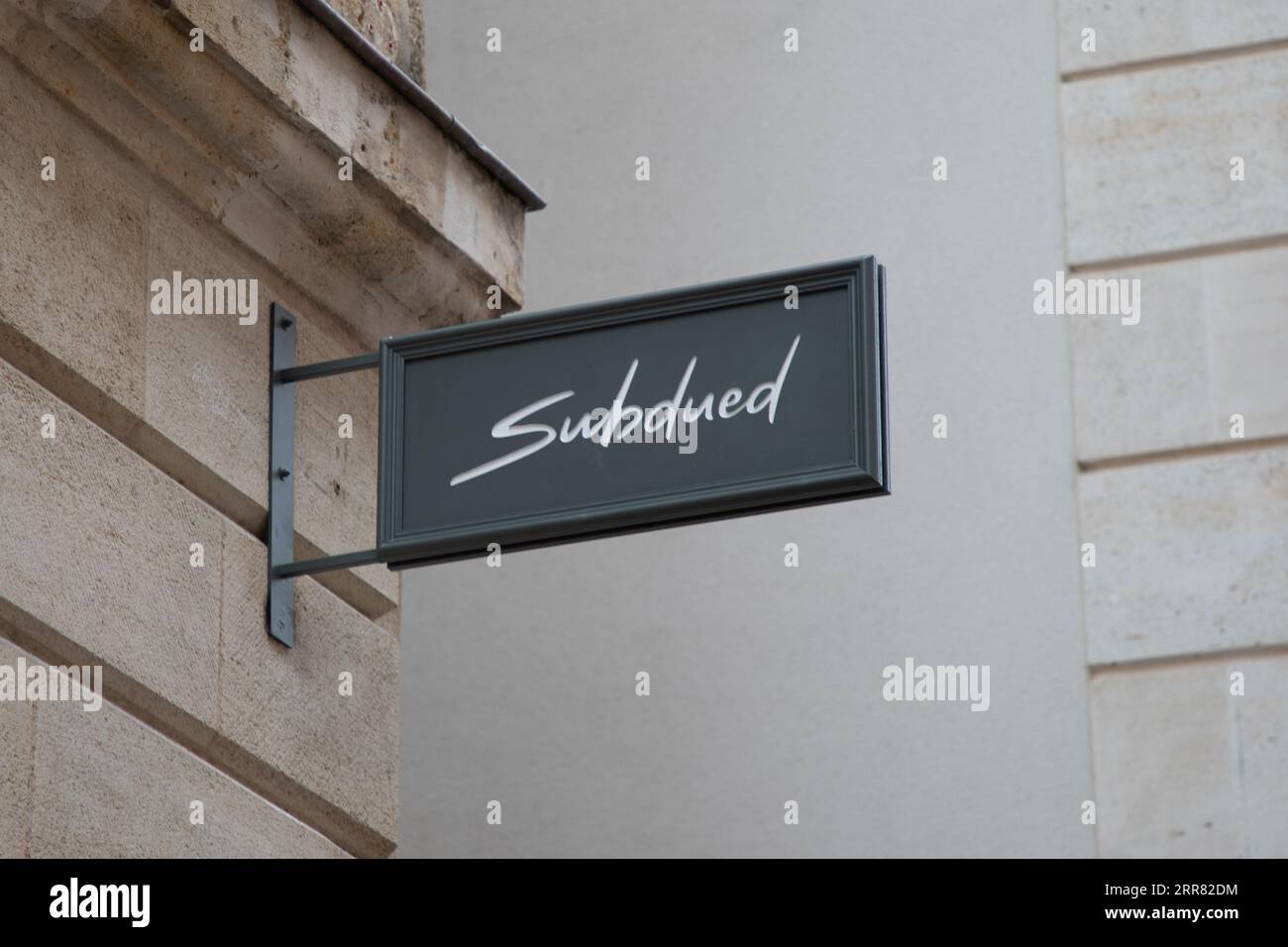 Milan , Italy - 09 01 2023 : Subdued logo brand and text sign shop wall ...