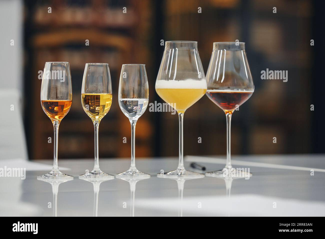 Blind tasting, various full glasses with different alcoholic beverages ...