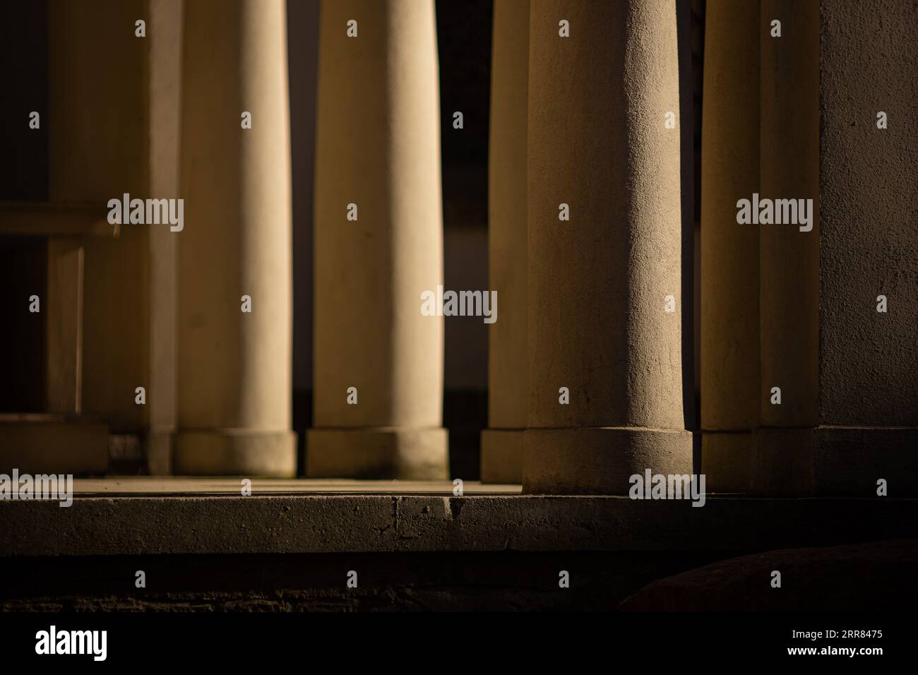 A series of architectural columns in a symmetrical formation along a ...