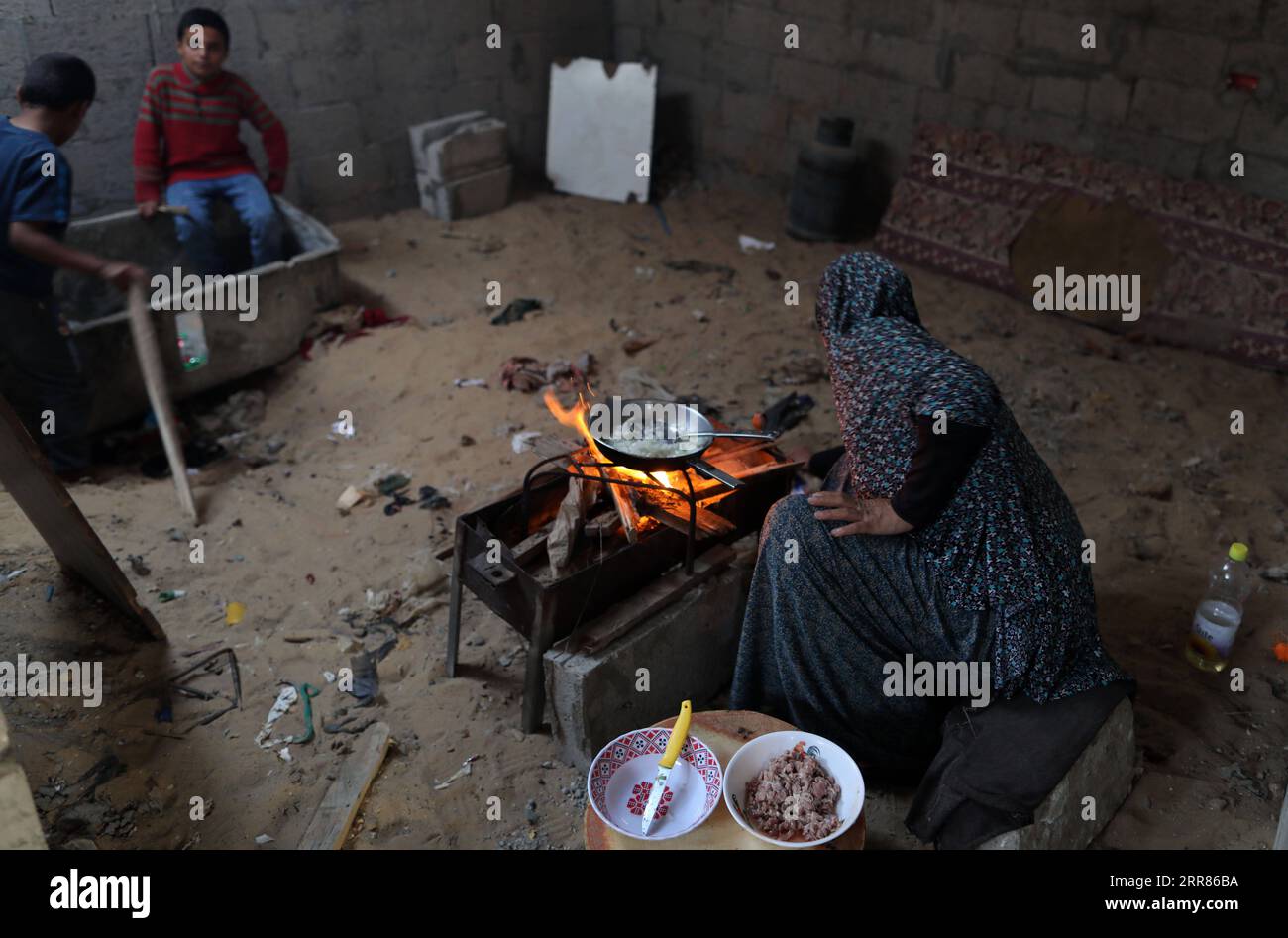 210421 -- GAZA, April 21, 2021 -- A Palestinian woman cooks food for ...