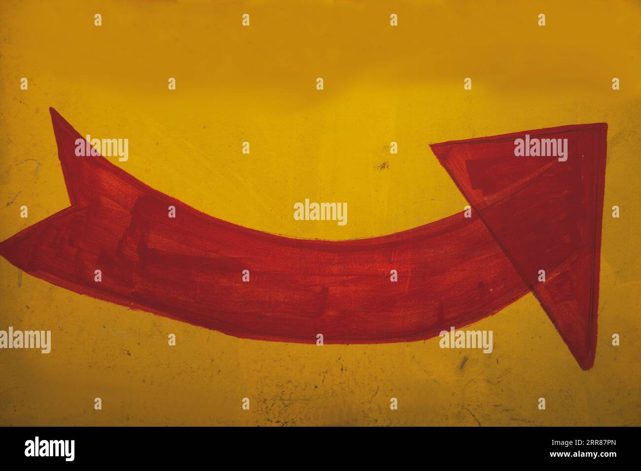Old worn red arrow symbol yellow background, leading the eye's way ...