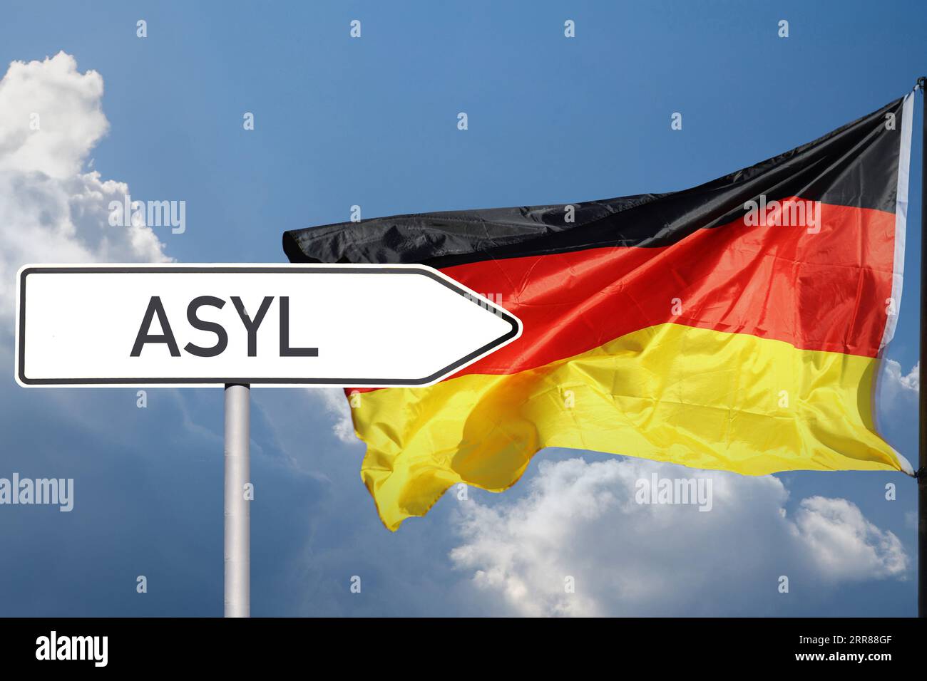 Sign with the german inscription Asyl (Asylum) points in the direction ...