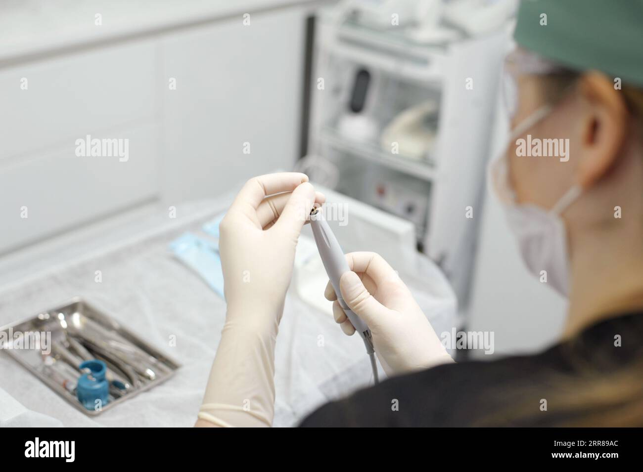 hands of doctor hold key nozzle and piezoelectric scaler removal of ...