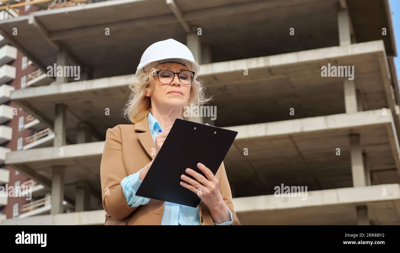 Entrepreneur makes notes on clipboard of building processes Stock Photo ...