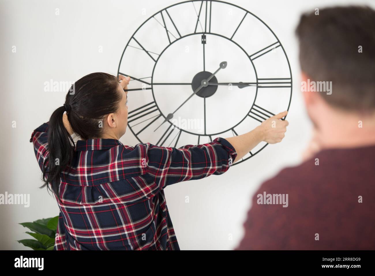 Man hanging on clock hi-res stock photography and images - Alamy