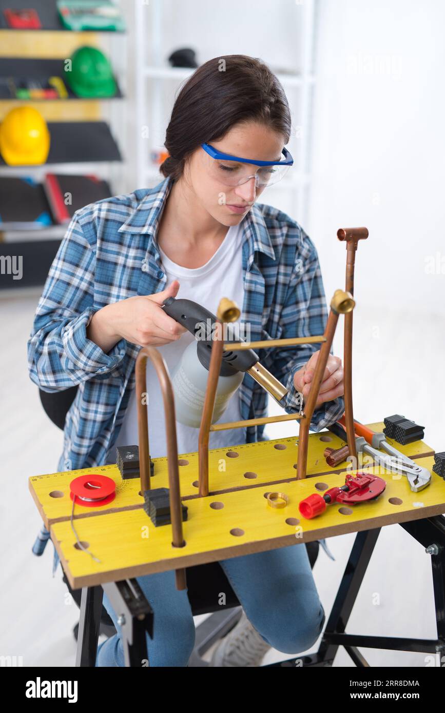 a young woman using blowtorch Stock Photo - Alamy