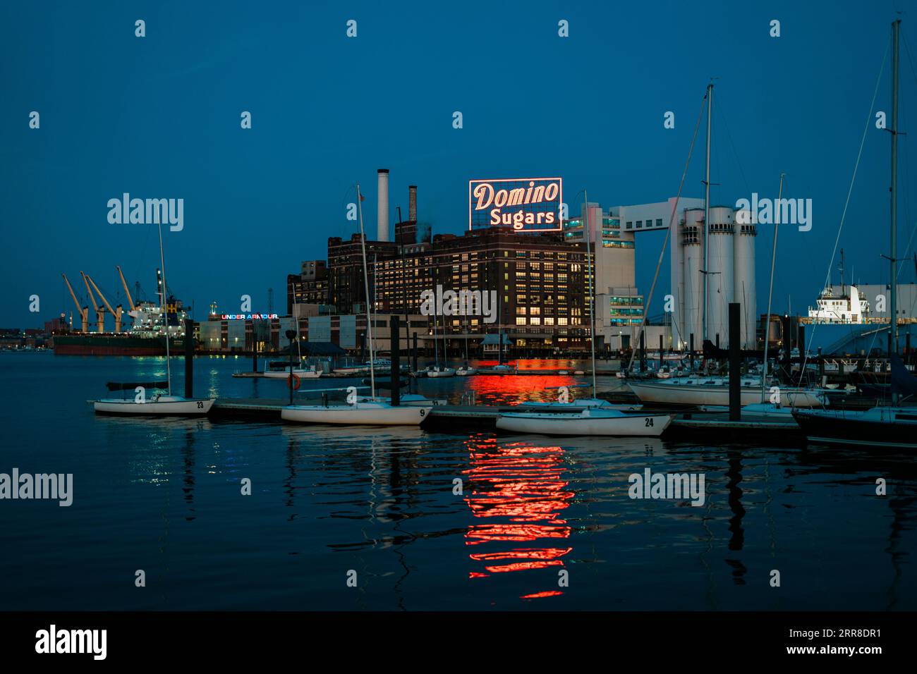 Domino Sugars Factory vintage neon sign and the harbor at night in ...