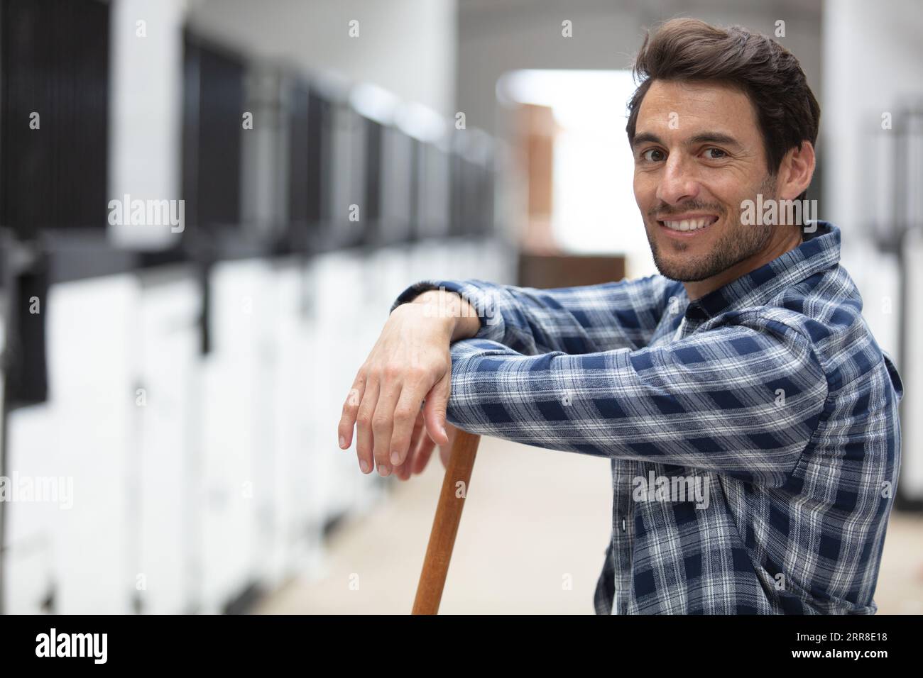 man farmer feeds cows with hay at farm outdoor Stock Photo - Alamy