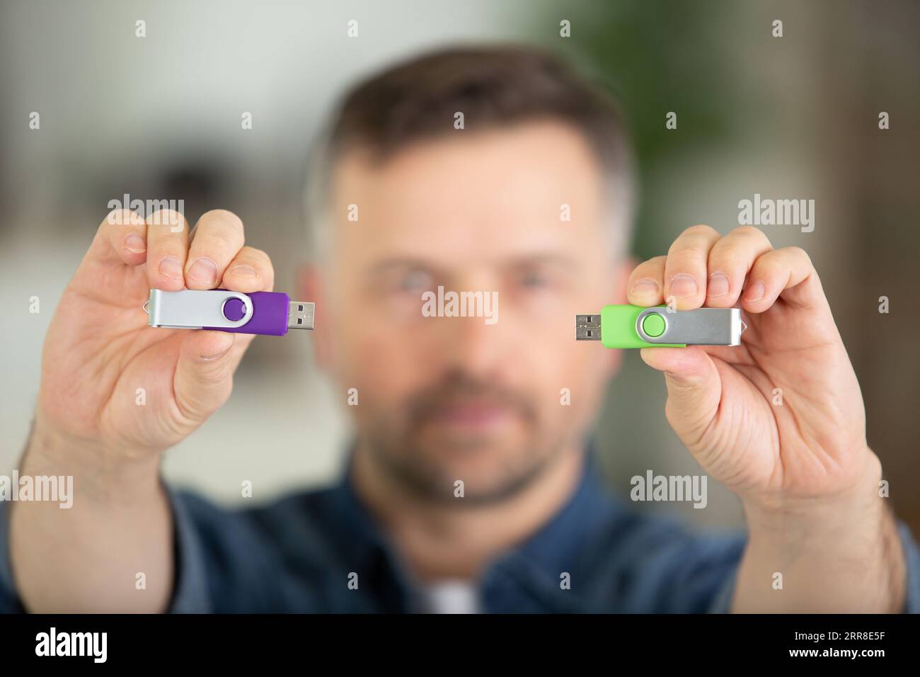 man is holding two usb memory sticks Stock Photo - Alamy