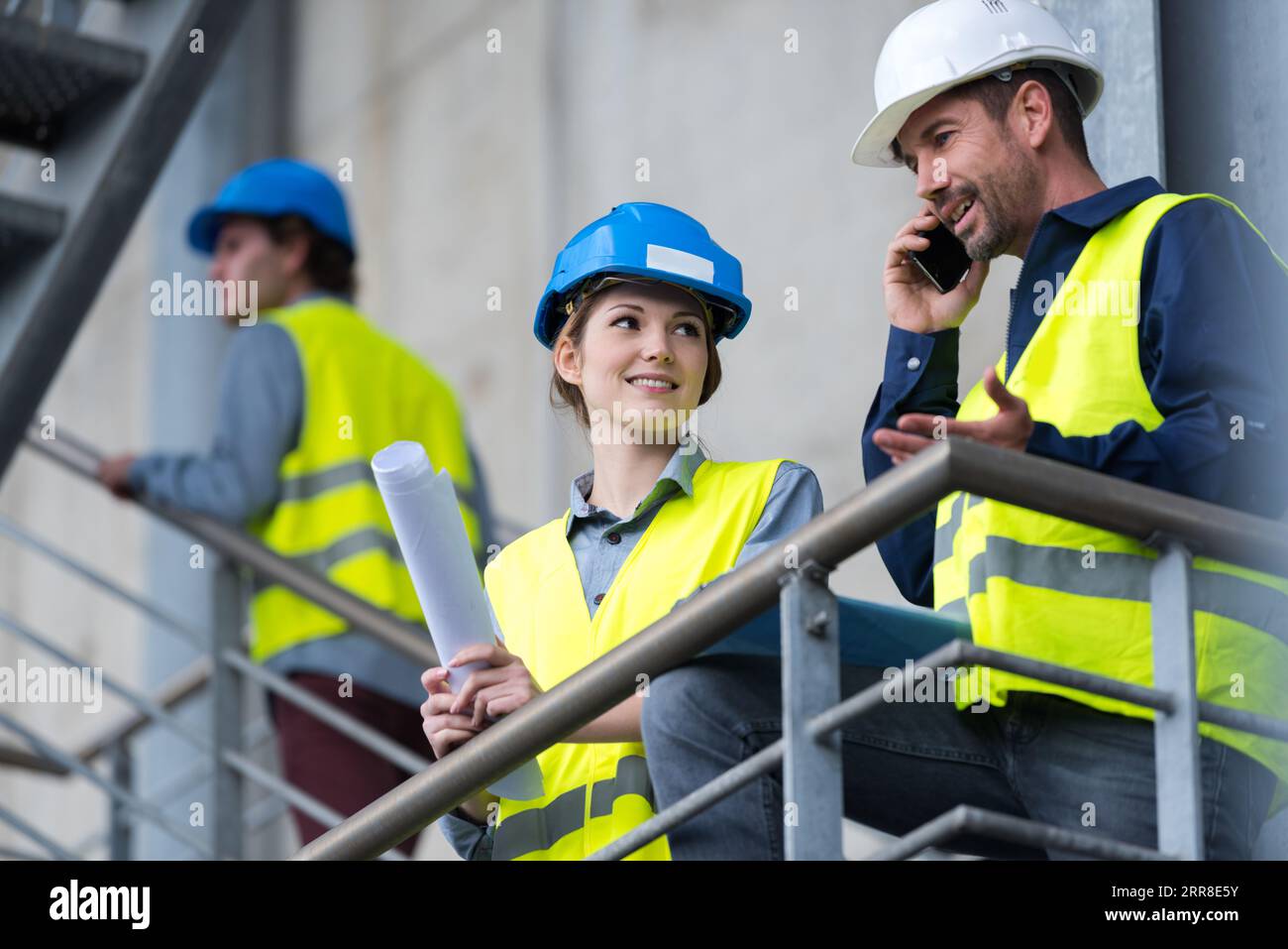 group of engineers wearing neon jacket Stock Photo - Alamy