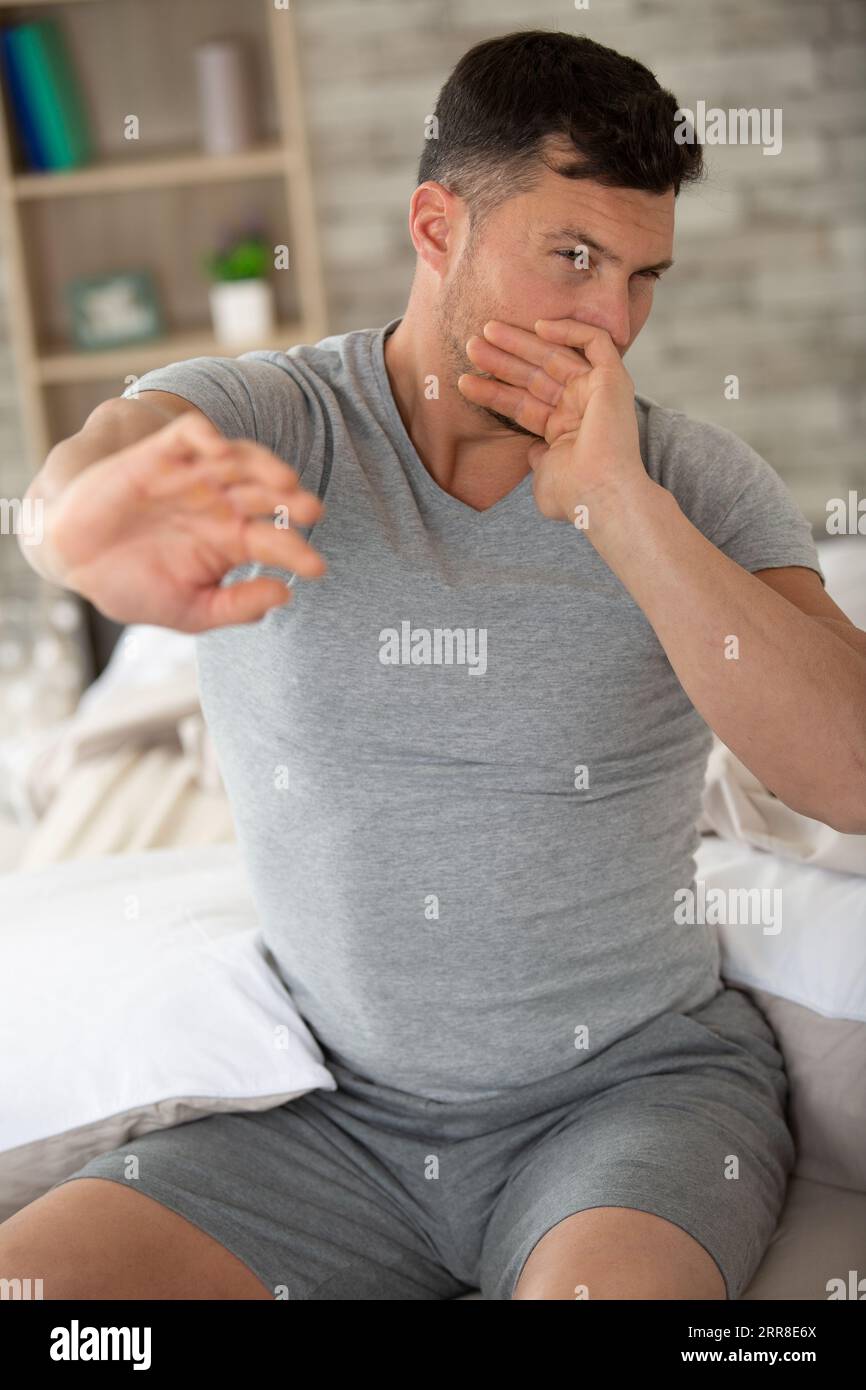 picture showing young man stretching in bed Stock Photo - Alamy