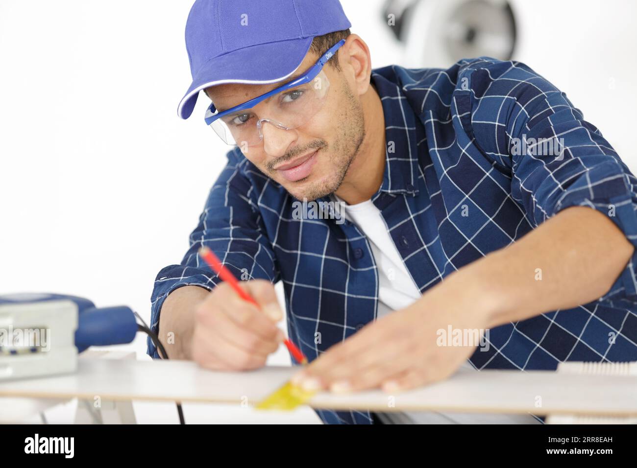 carpenter with pencil drawing project on a piece of wood Stock Photo ...