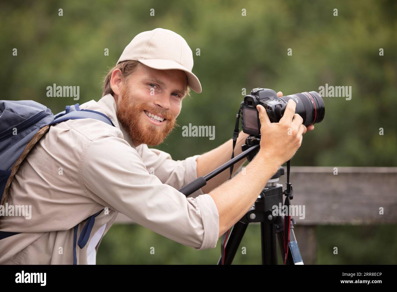 male photographer using tripod for landscape photography Stock Photo ...