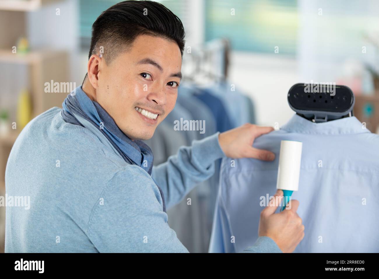 asian man cleaning his shirts Stock Photo - Alamy