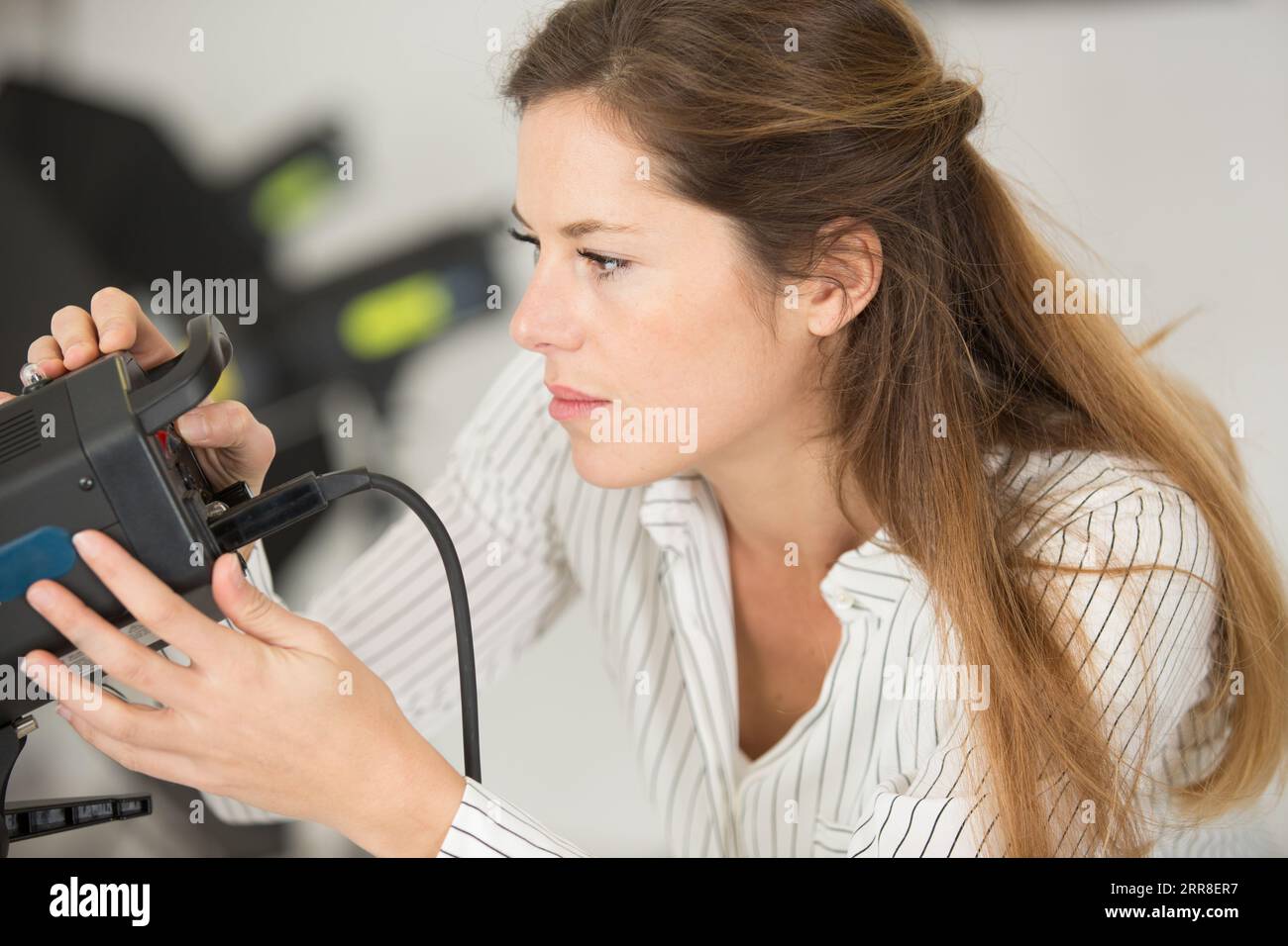 woman setting up studio equipment Stock Photo - Alamy