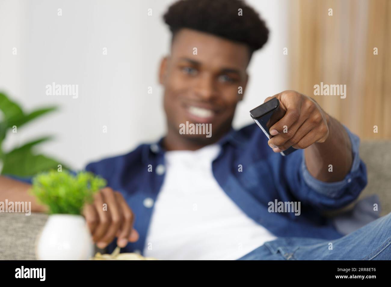 1 man watching tv hi-res stock photography and images - Alamy