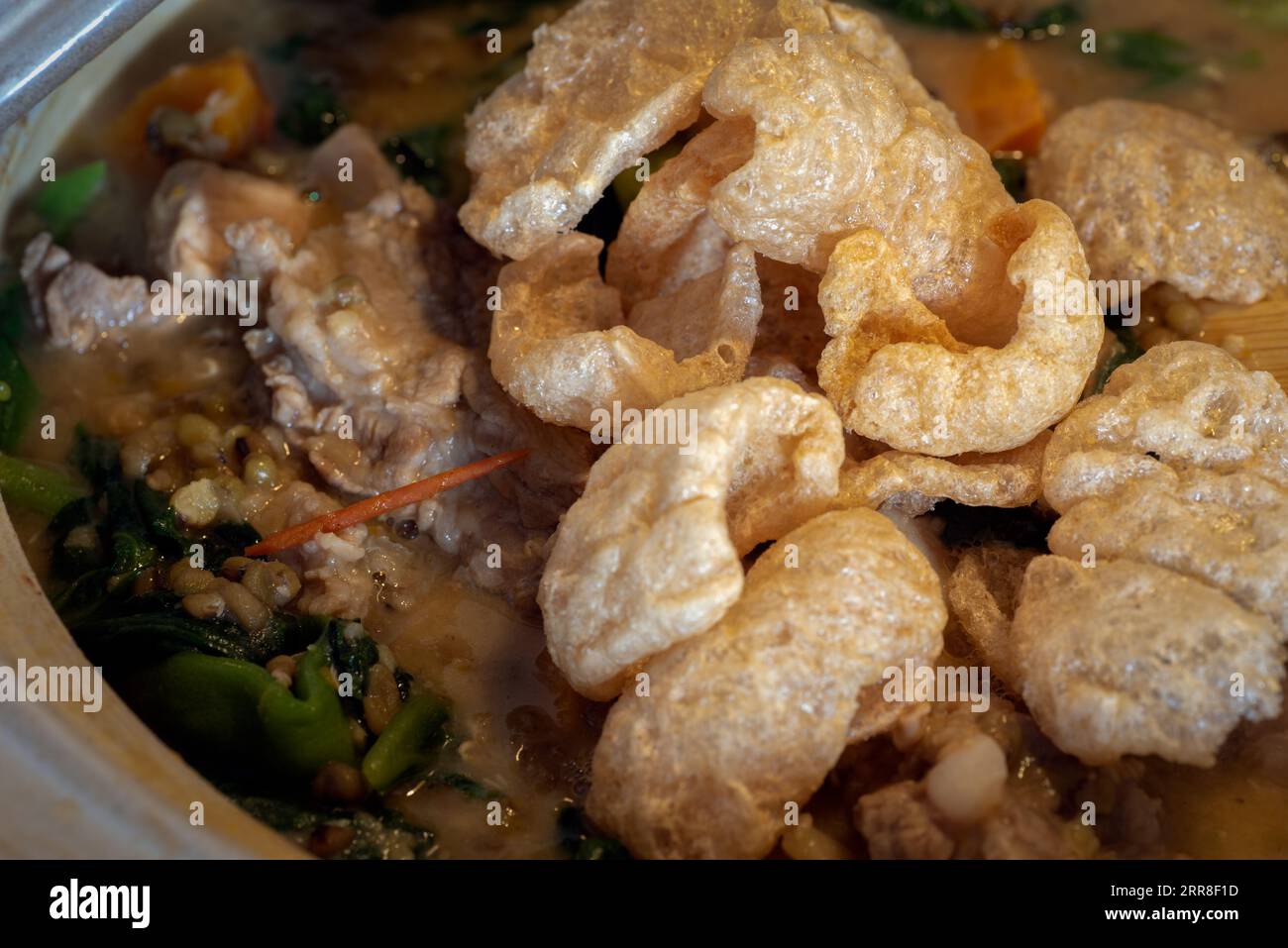 Pork chicharon on ginisang munggo, monggo with baboy and alugbati Stock ...