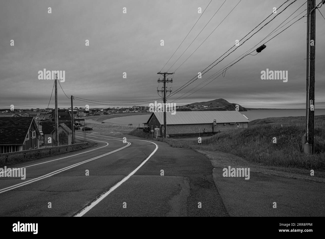 A grayscale of a highway lined with rural houses on the coastline Stock ...