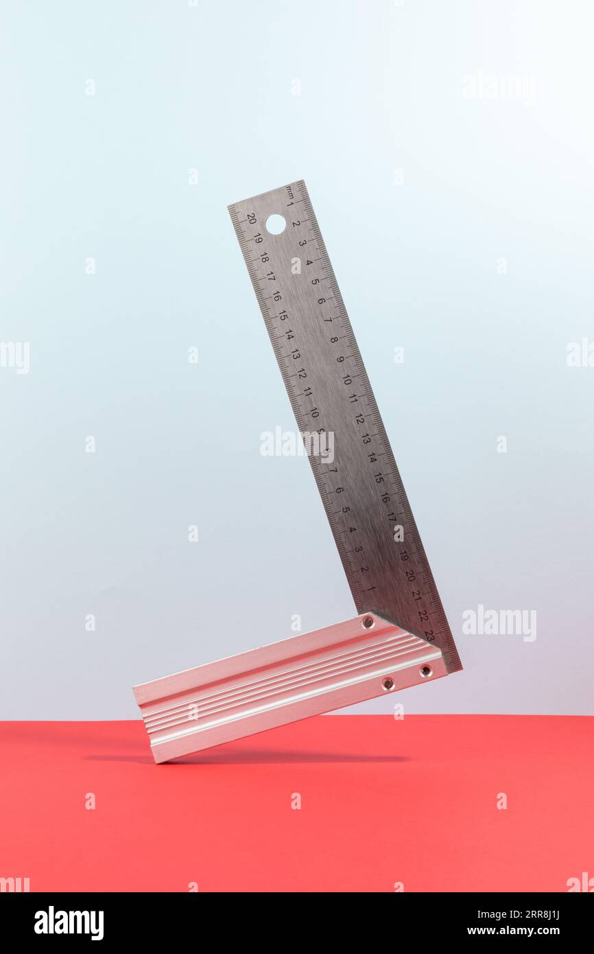 Steel measure corner with a measurement scale on cyan and yellow ...