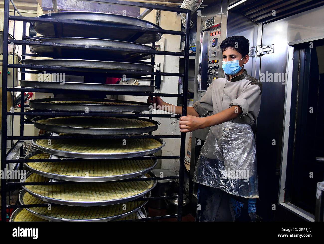 210509 -- DAMASCUS, May 9, 2021 -- A sweet maker prepares traditional ...