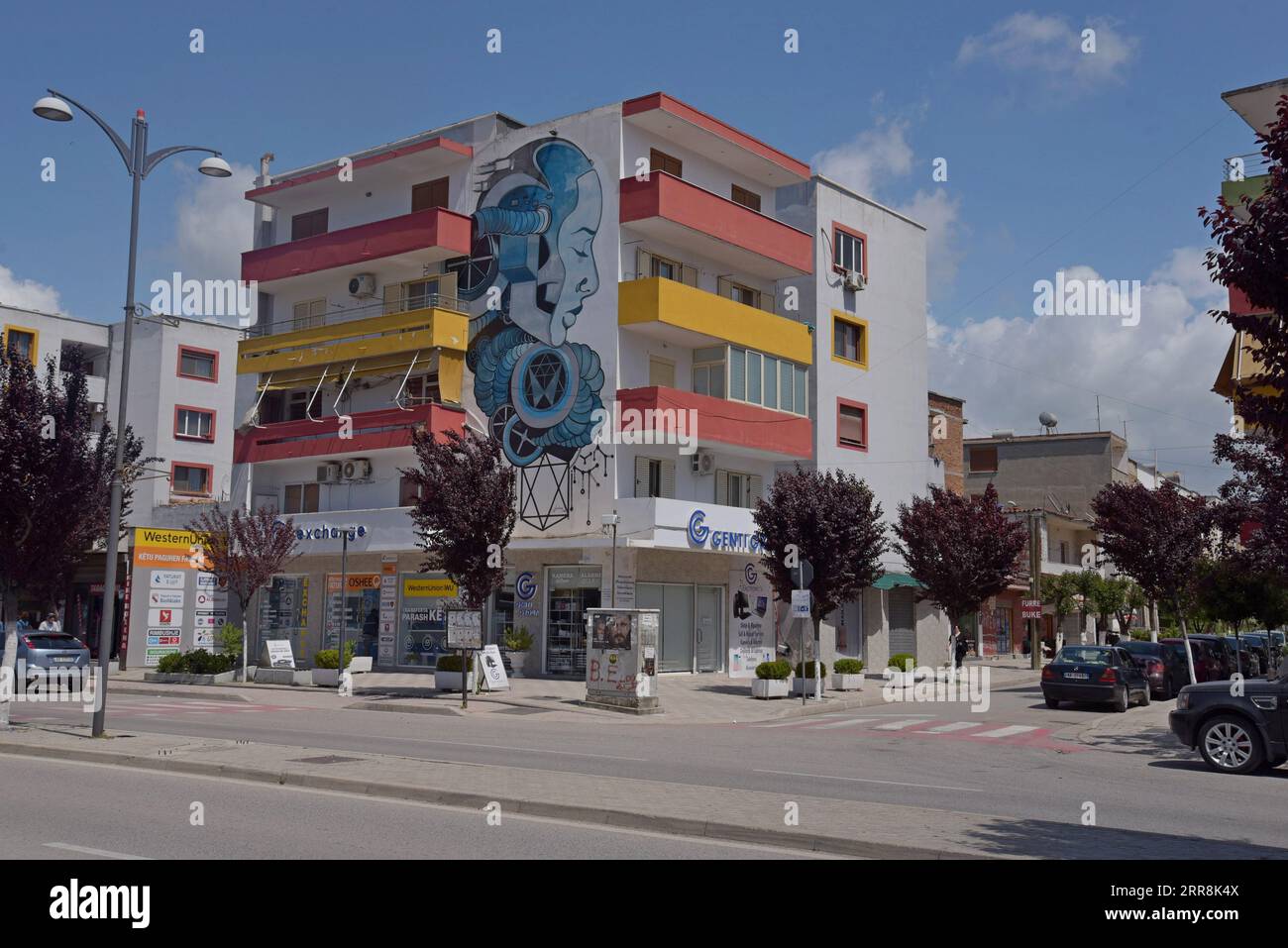 Colourful painted apartment blocks with street art murals in the town ...
