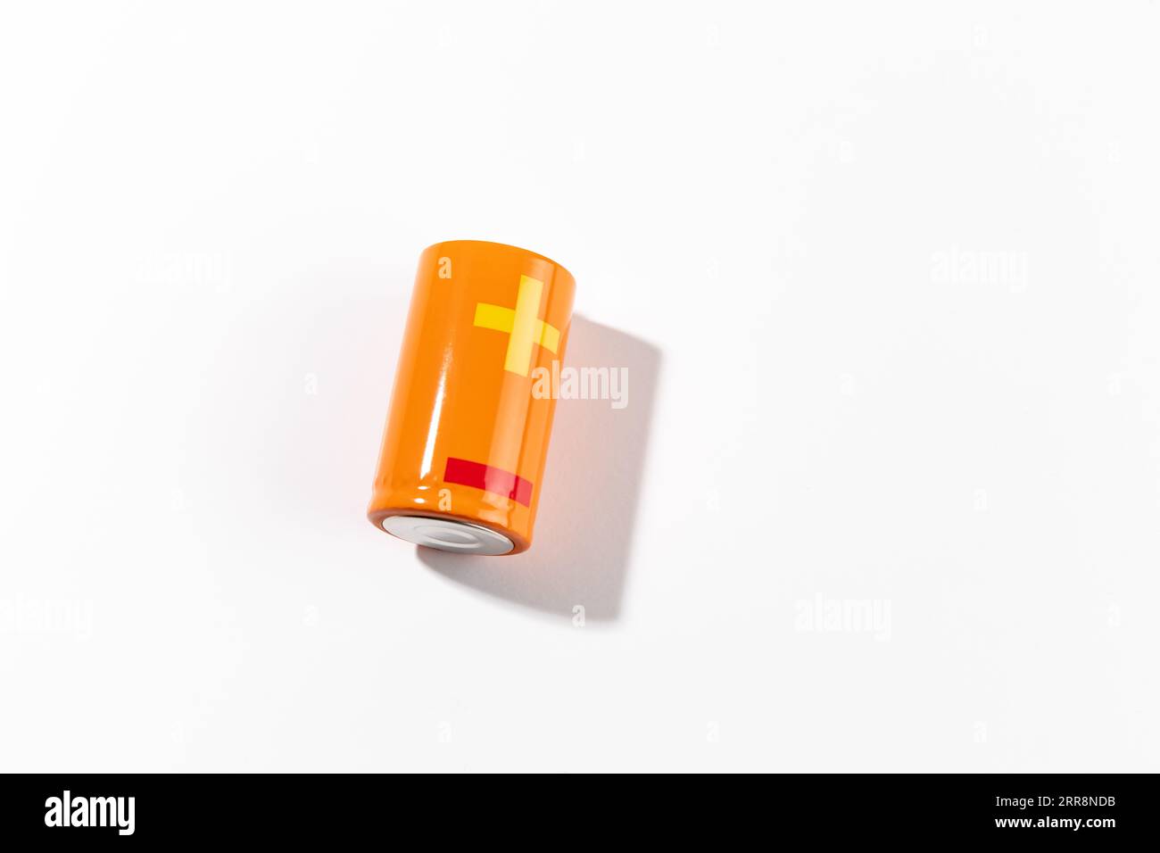 Orange battery on white background, energy concept Stock Photo - Alamy
