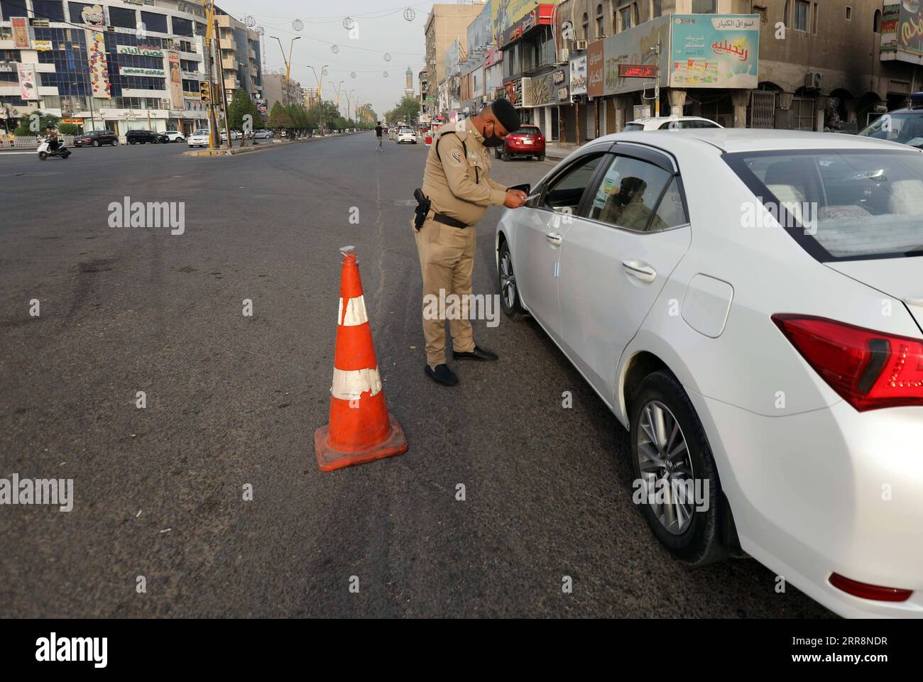 210513 -- BAGHDAD, May 13, 2021 -- An Iraqi security member checks a ...