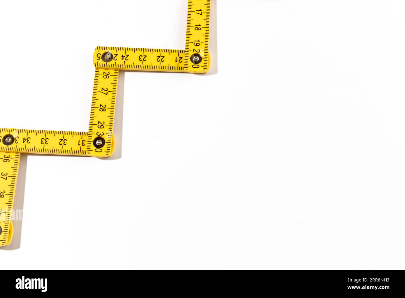 A carpenters ruler on white background Stock Photo - Alamy