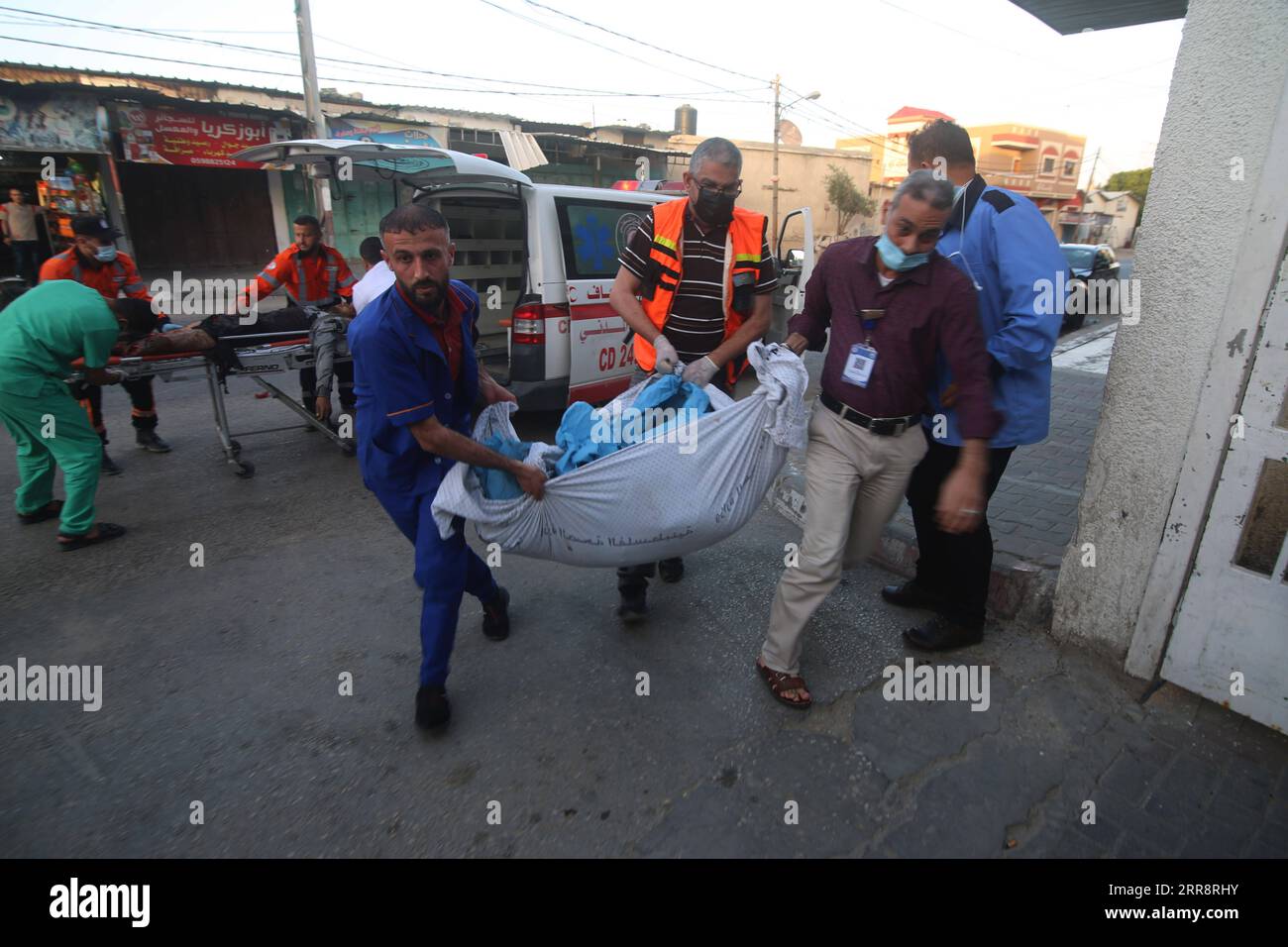 210517 -- GAZA, May 17, 2021 -- Paramedics carry bodies of two ...