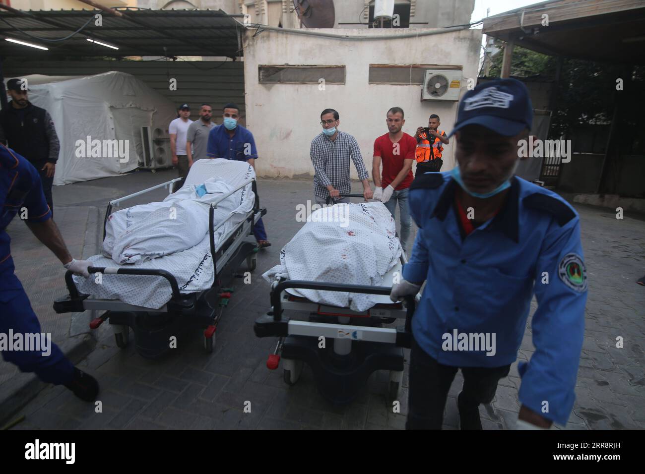 210517 -- GAZA, May 17, 2021 -- Paramedics carry bodies of two ...