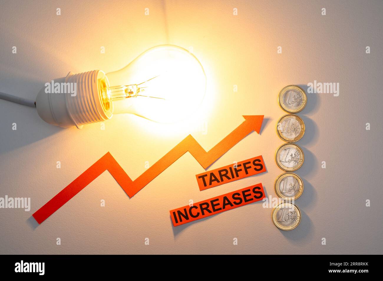 Illuminated light bulb, next to coins and ascending line, and text ...