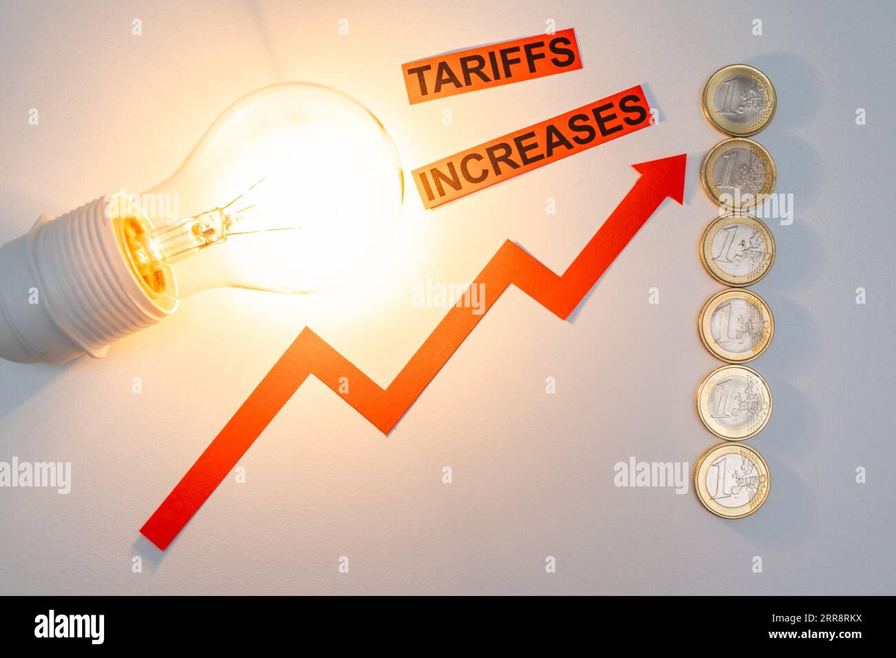 Illuminated light bulb, next to coins and ascending line, and text ...