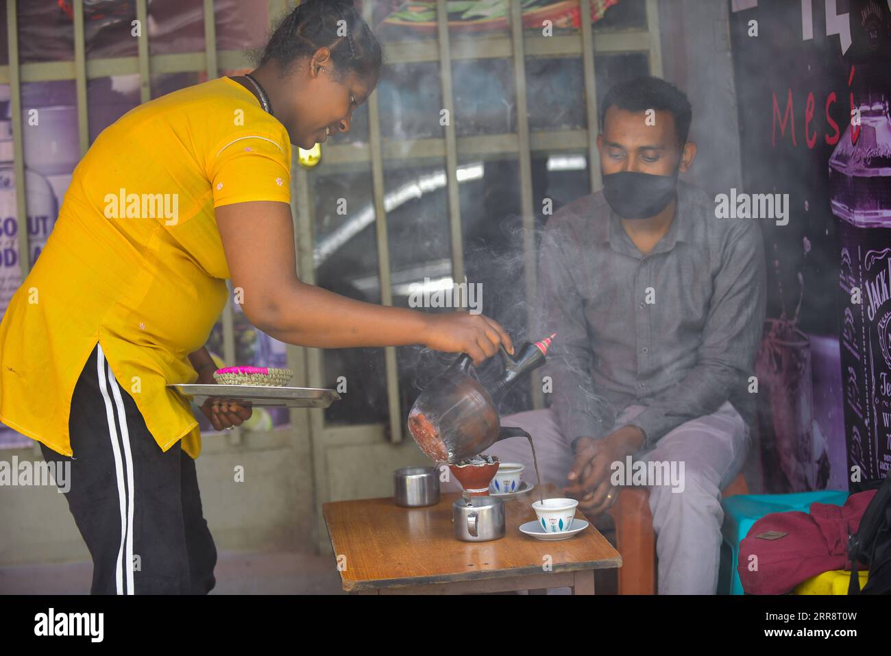 210517 -- ADDIS ABABA, May 17, 2021 -- A coffee vender serves ...
