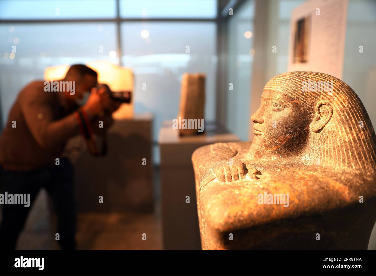 210518 -- CAIRO, May 18, 2021 -- A man takes photo of an exhibit at a ...
