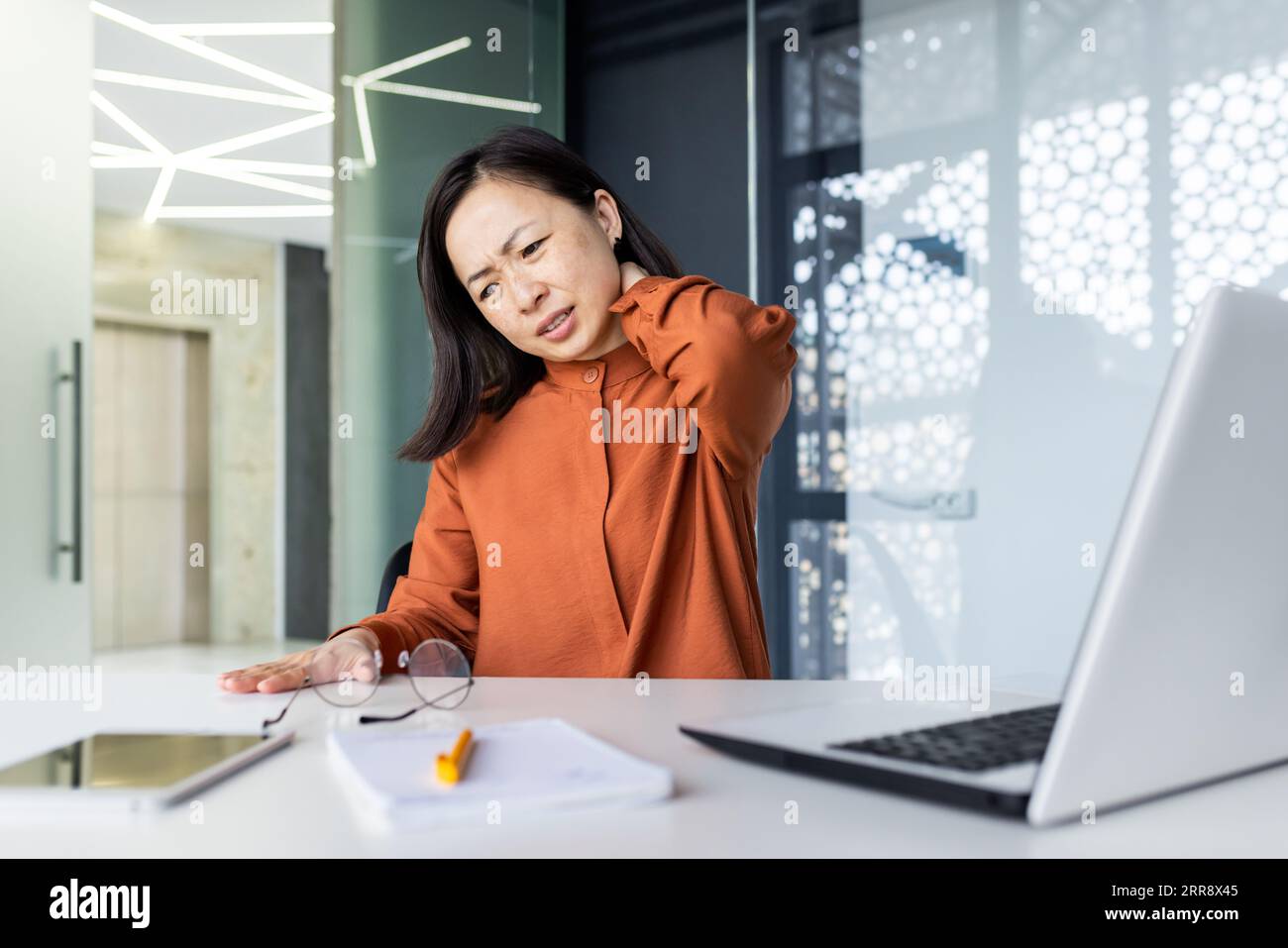 Office worker neck pain, asian woman massaging neck muscle from long ...